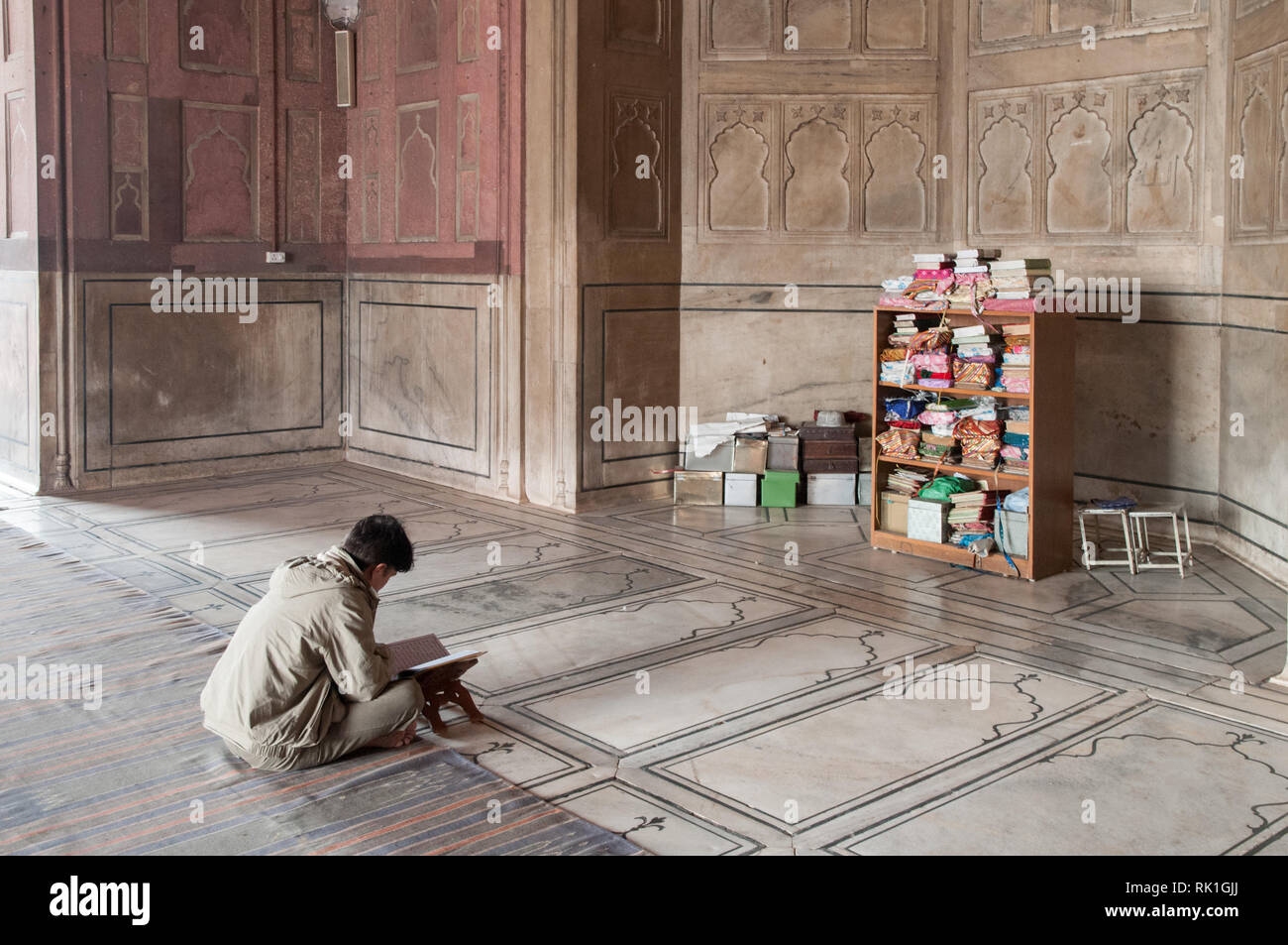 Muslim reading Quran at Jama Masjid mosque in Old Dehli. The mosque was ...