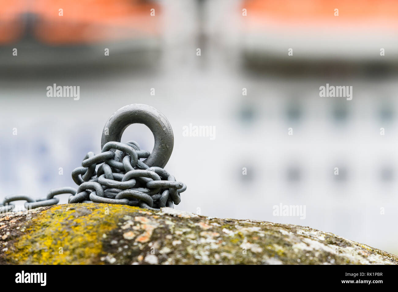 Detail of iron loop and chain anchorage secured to rock Stock Photo - Alamy