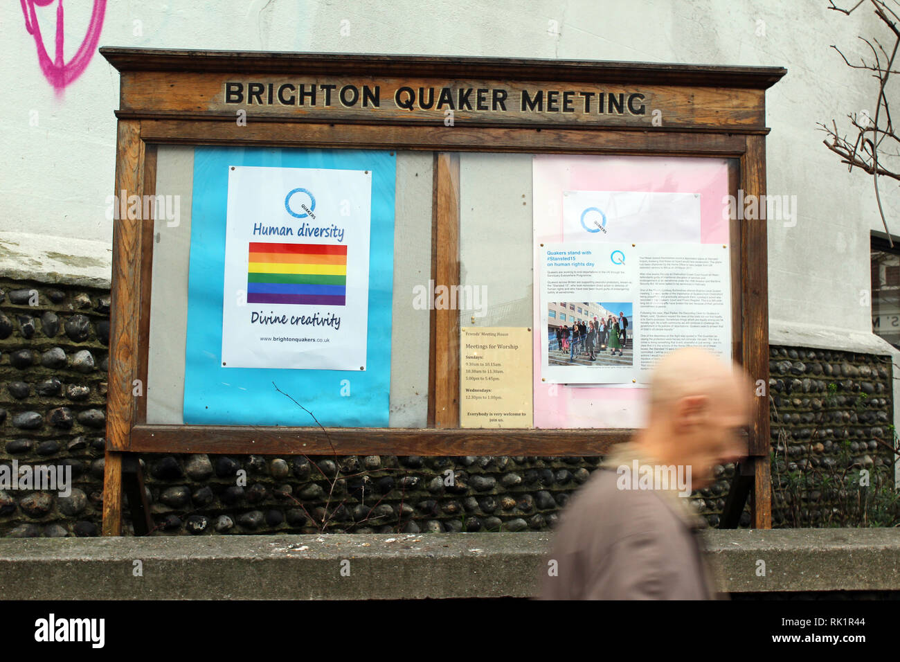 Old man crossing Brighton Quaker Meeting Church sign with gay rainbow ...