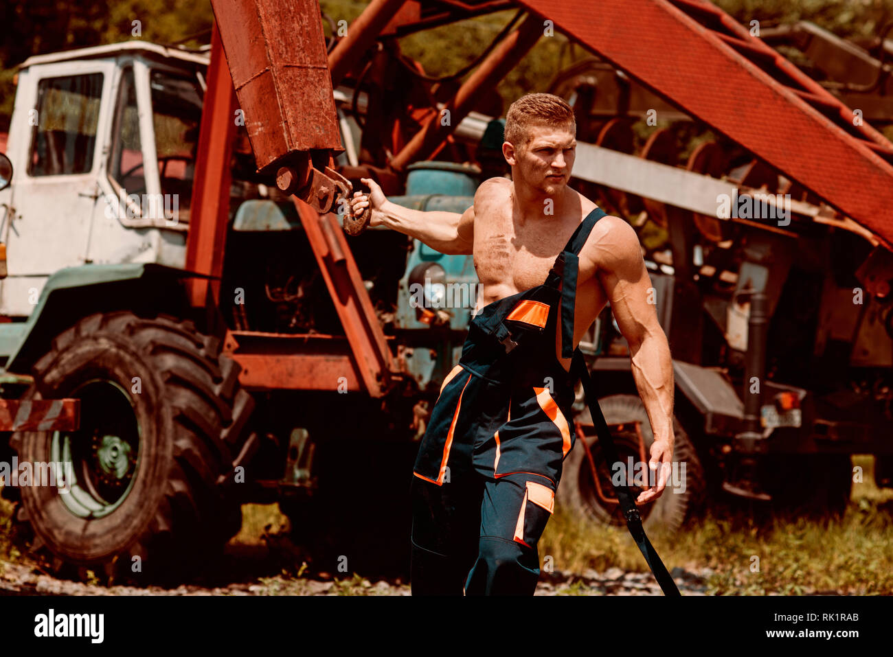 Power concept. Power man pull tractor with crane. Power lifter at ...