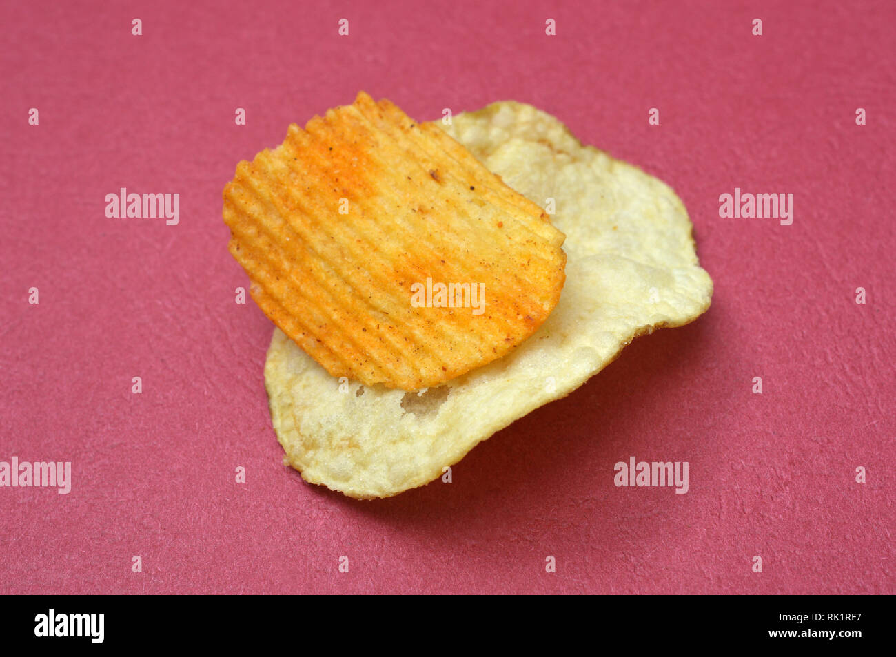 potato chips on red background, image Stock Photo - Alamy