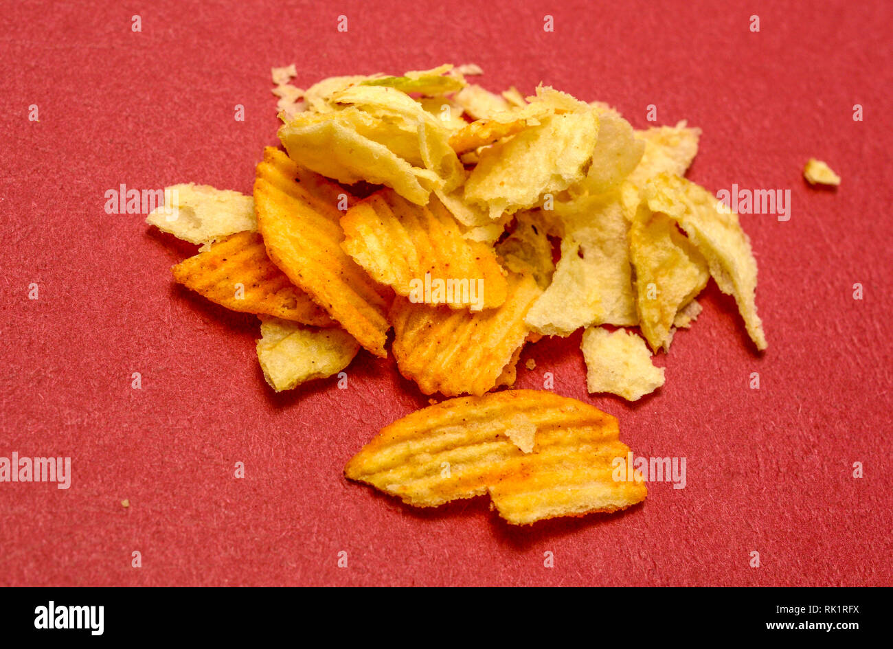 potato chips on red background, image Stock Photo - Alamy