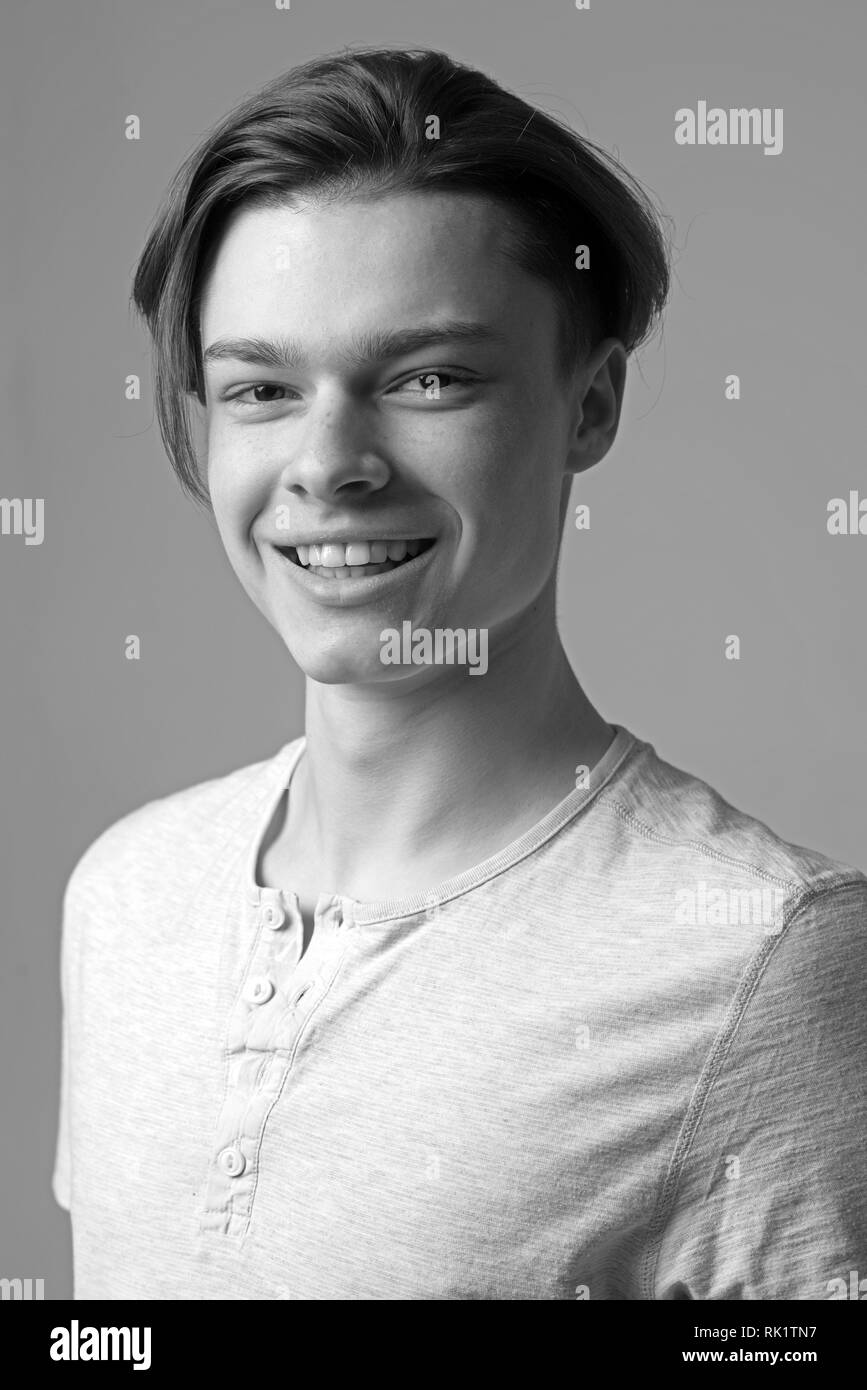 Guy on smiling happy face in light shirt, grey background. Macho with ...