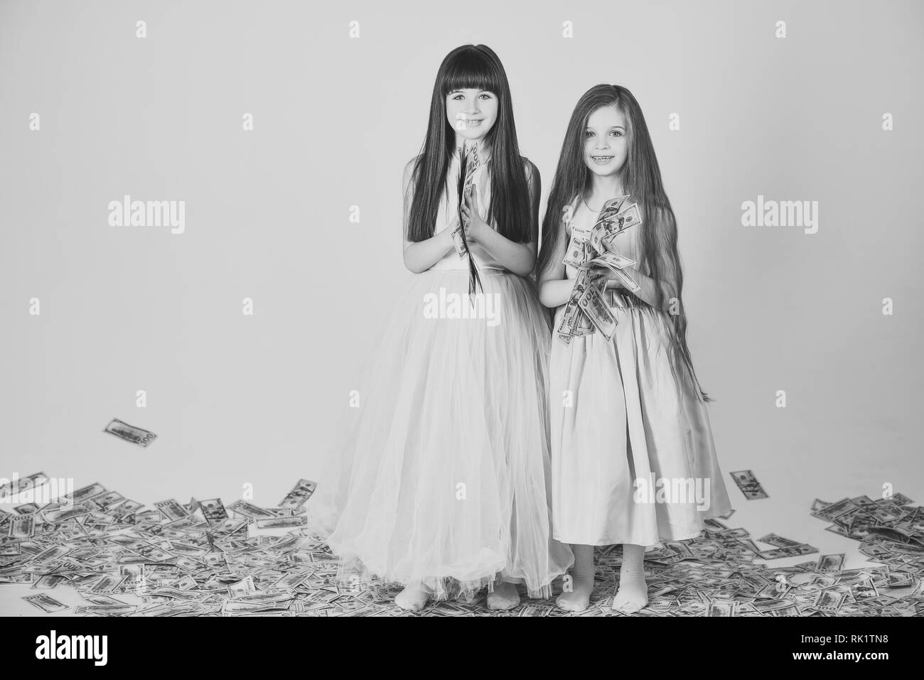 little girls sisters with money, dollars, savings Stock Photo - Alamy