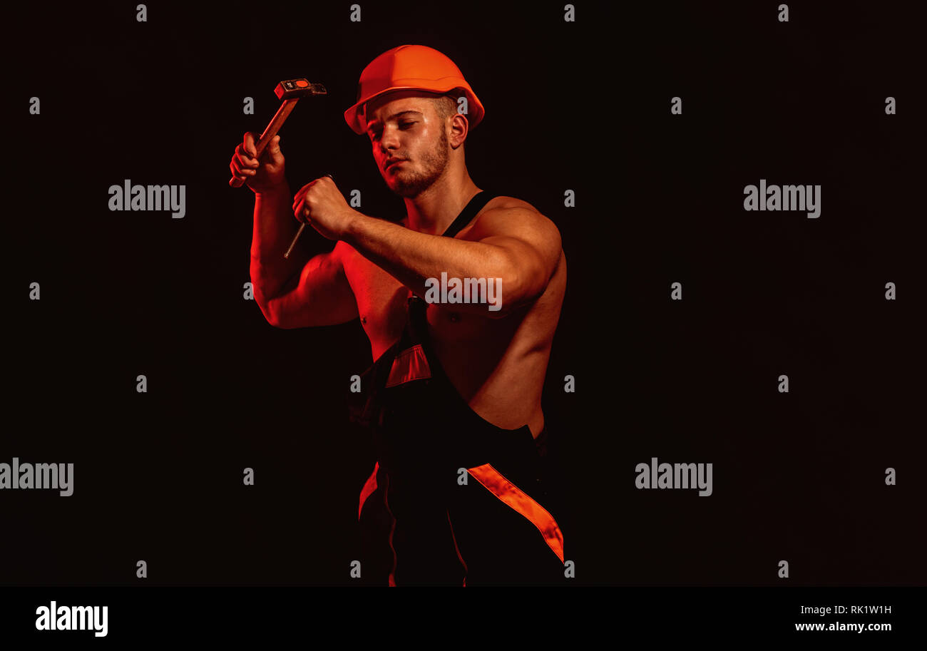 The rest being still under construction. Muscular man builder at work ...