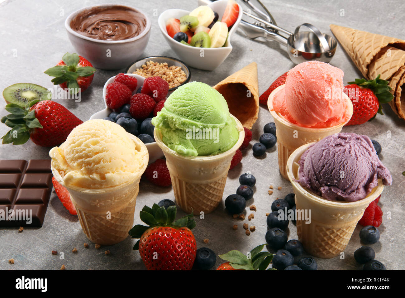 Set of ice cream scoops of different colors and flavours with berries ...