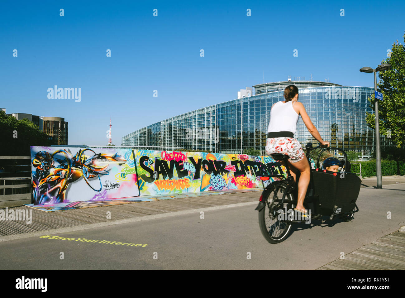 STRASBOURG, FRANCE - SEP 12, 2018: Young woman on Dutch bike with kids ...