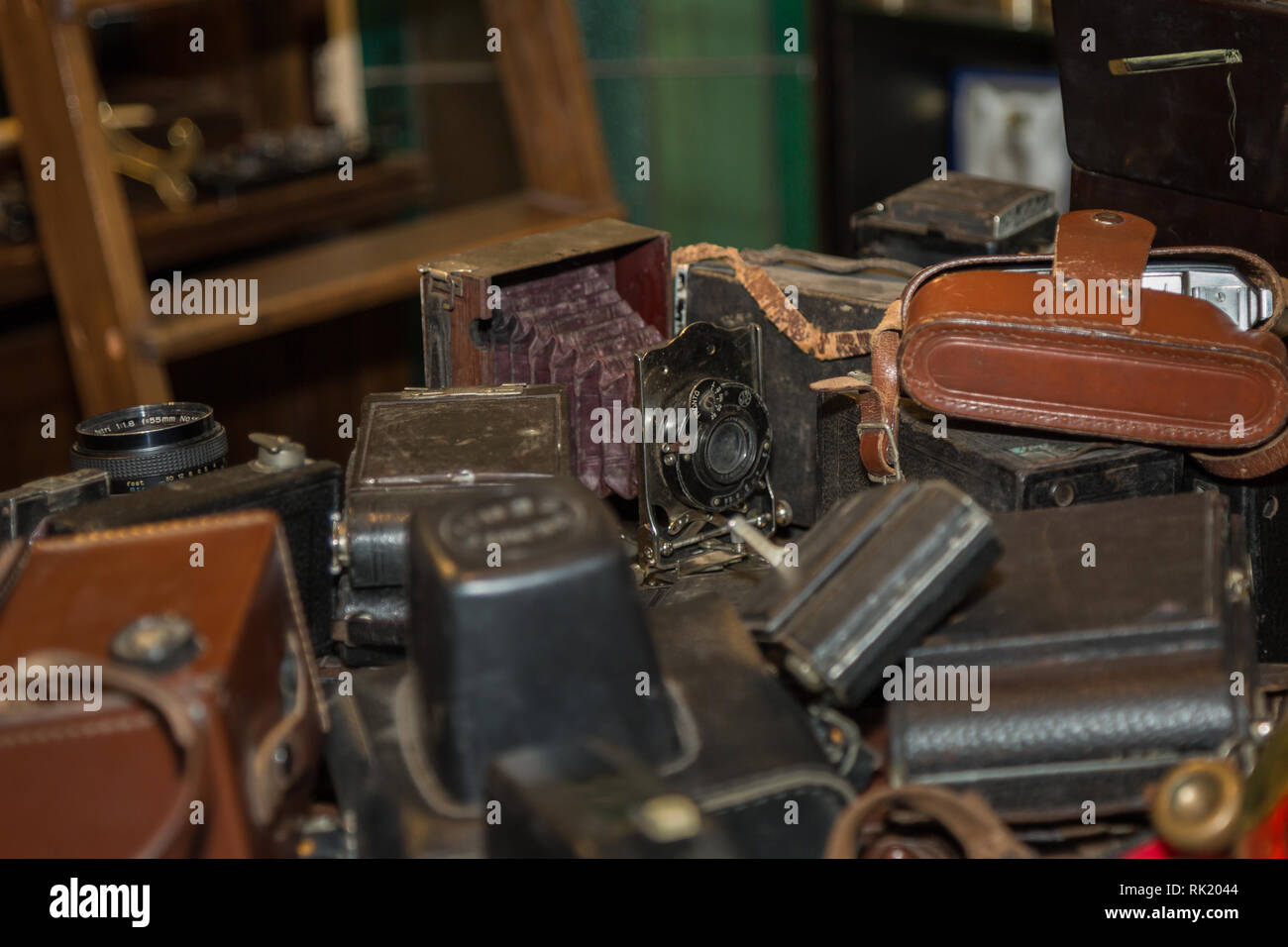 Antique Folding Camera with Bellows over a Pile of Old Cameras Stock ...