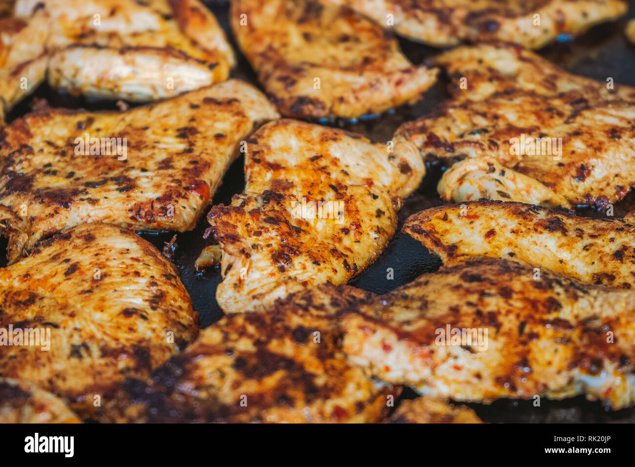 Closeup view of hot roasted grilled spicy chicken laying on frying ...