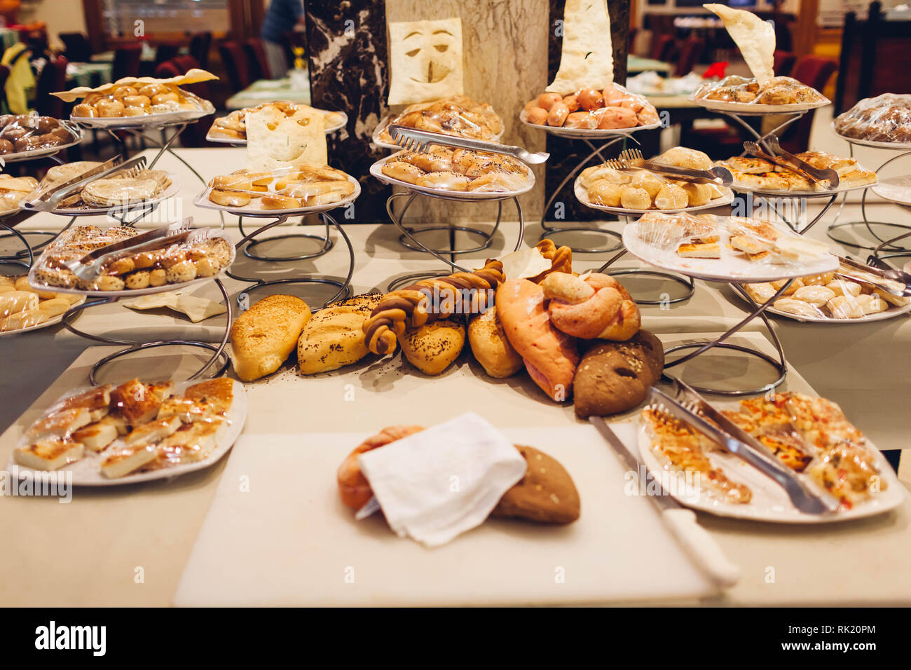 Variety of bread in hotel dining room. Assortment of food. All ...
