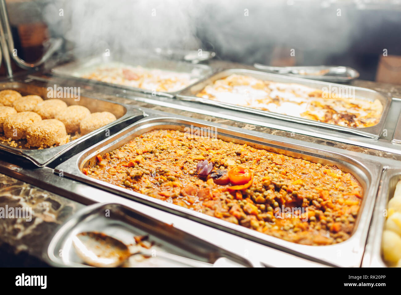 Assortment of fresh dishes displayed in hotel buffet. Variety of food ...