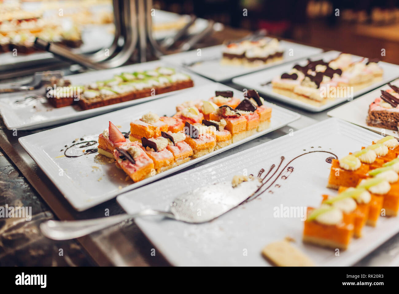 Assortment of fresh desserts displayed in hotel buffet. Variety of ...