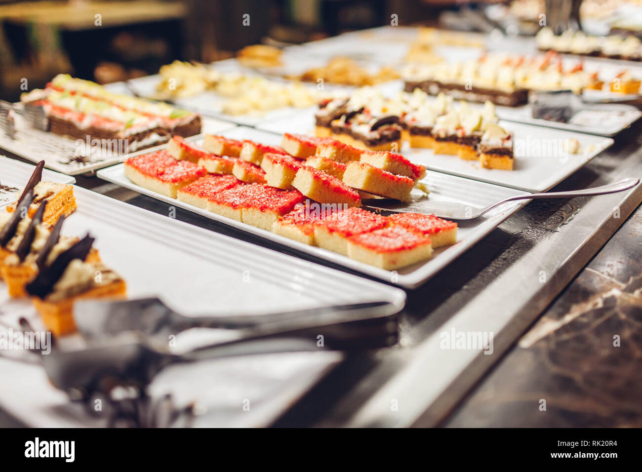 Assortment of fresh desserts displayed in hotel buffet. Variety of ...