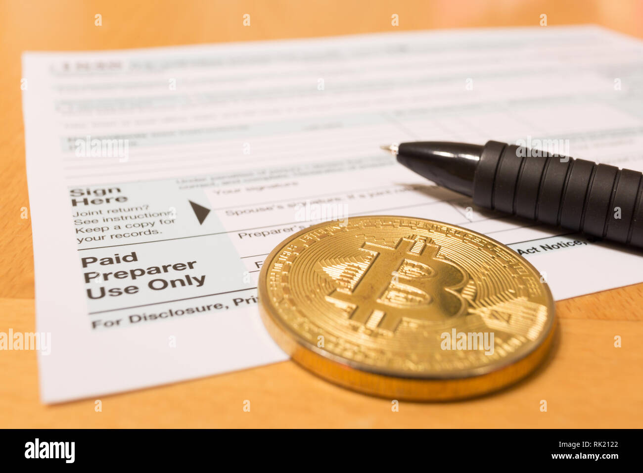 Bitcoin coin with 1040 income tax form for 2018 for filing on April 15 ...