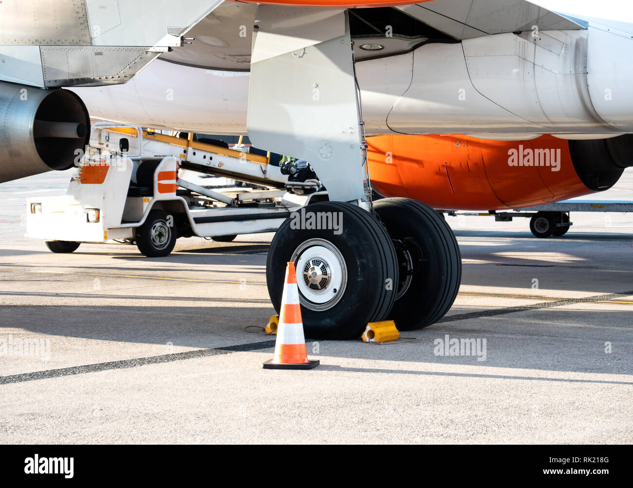 Detail of aircraft wheel of a large orange aircraft on tarmac Stock ...