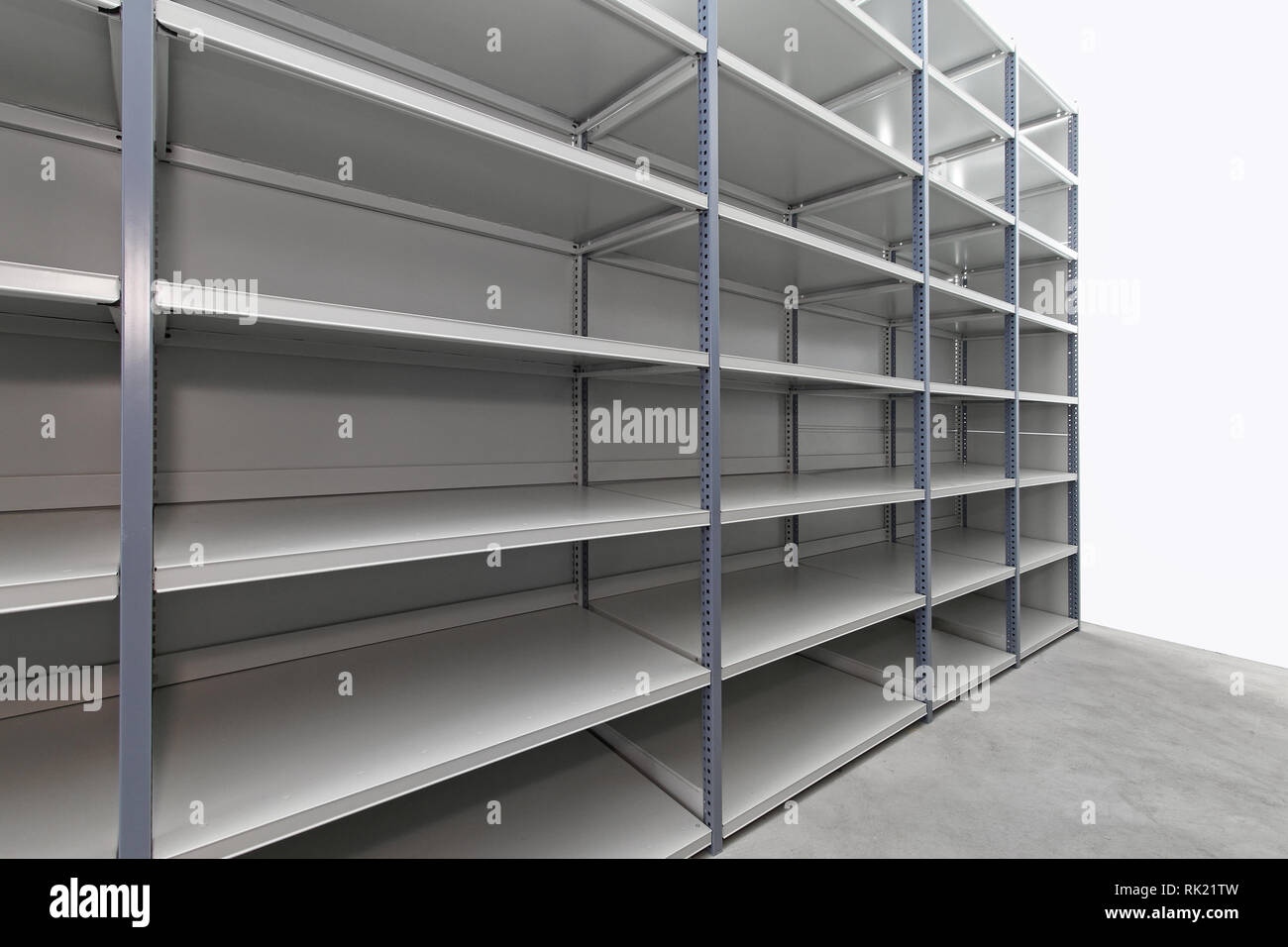 Empty metal shelf in storage room Stock Photo - Alamy