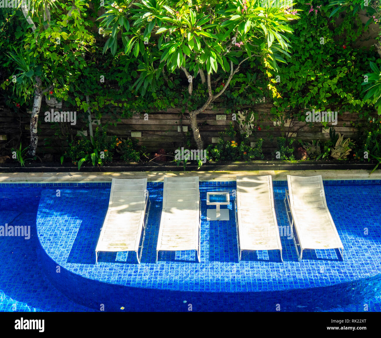 Deck chairs in the swimming pool of Jimbaran Bay Beach Resort & Spa ...