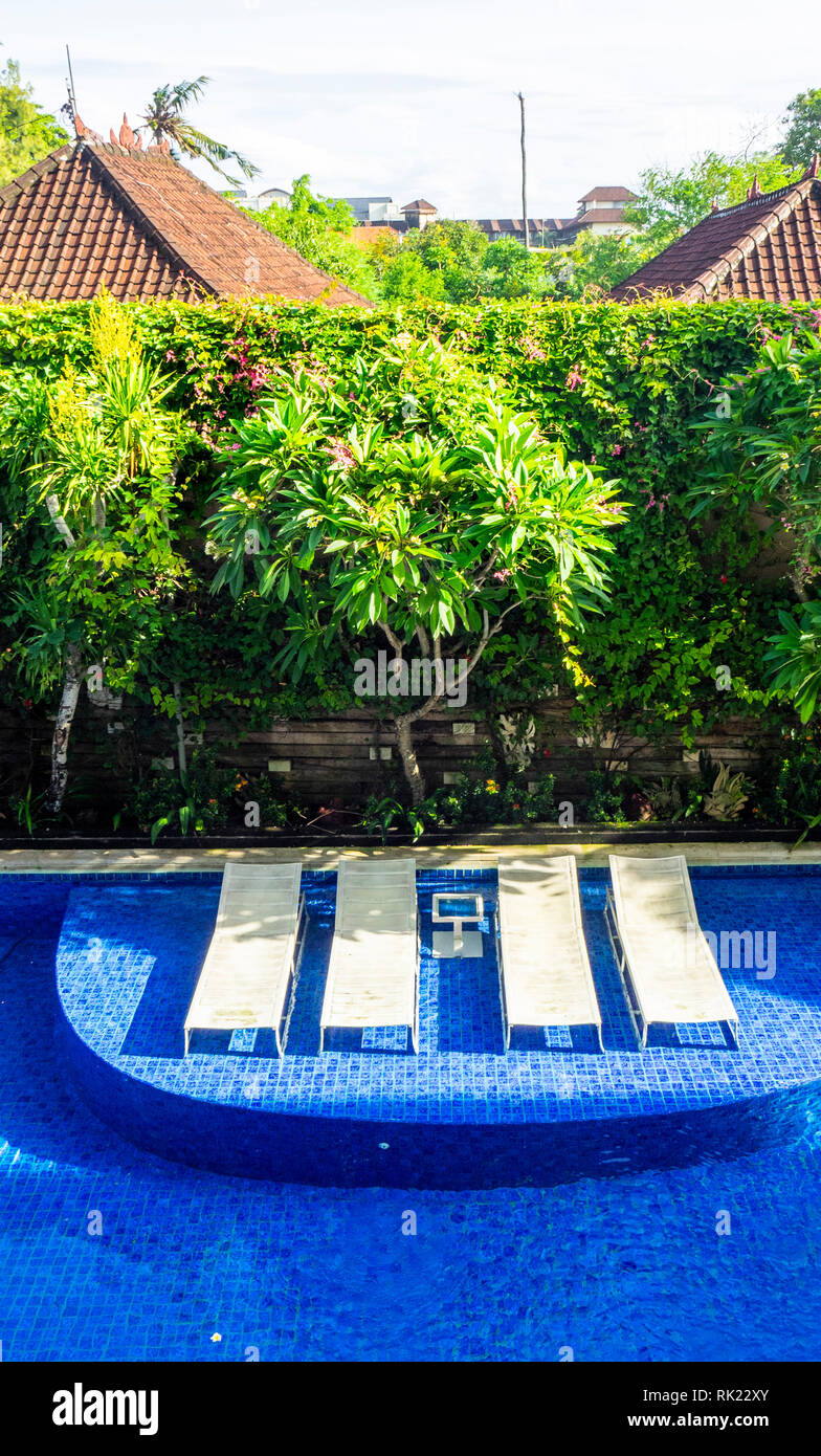 Deck chairs in the swimming pool of Jimbaran Bay Beach Resort & Spa ...