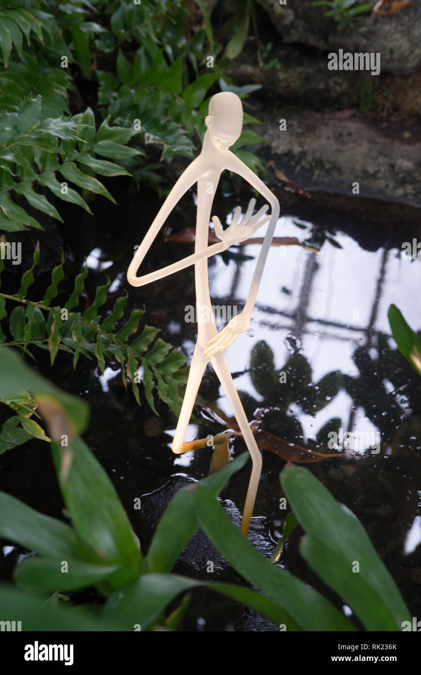 Glass artistic stick figure in garden setting Stock Photo - Alamy