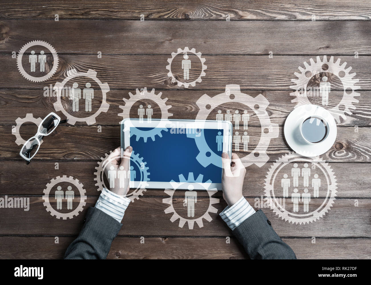 Concept of teamworking and connection with gears mechanism and tablet ...