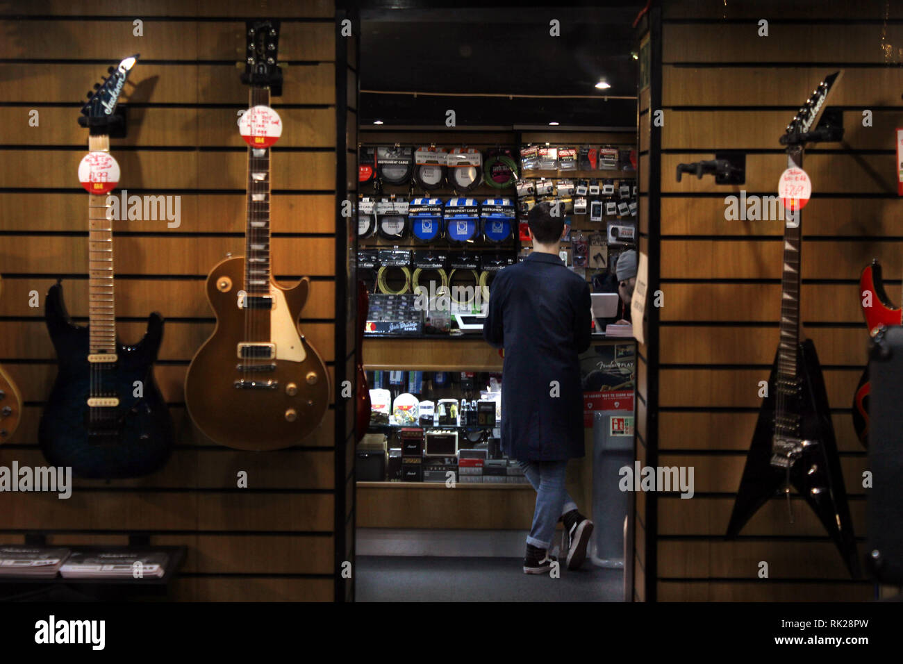 Customer inside of music instruments store, Brighton, England, UK Stock ...