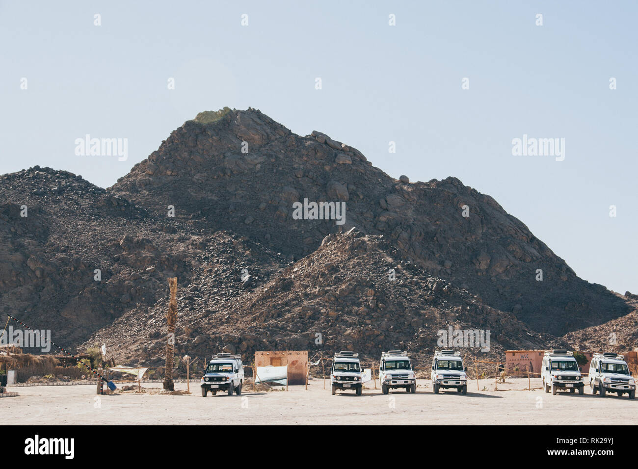 Six tourist jeeps in egyptian desert with mountains on background Stock ...