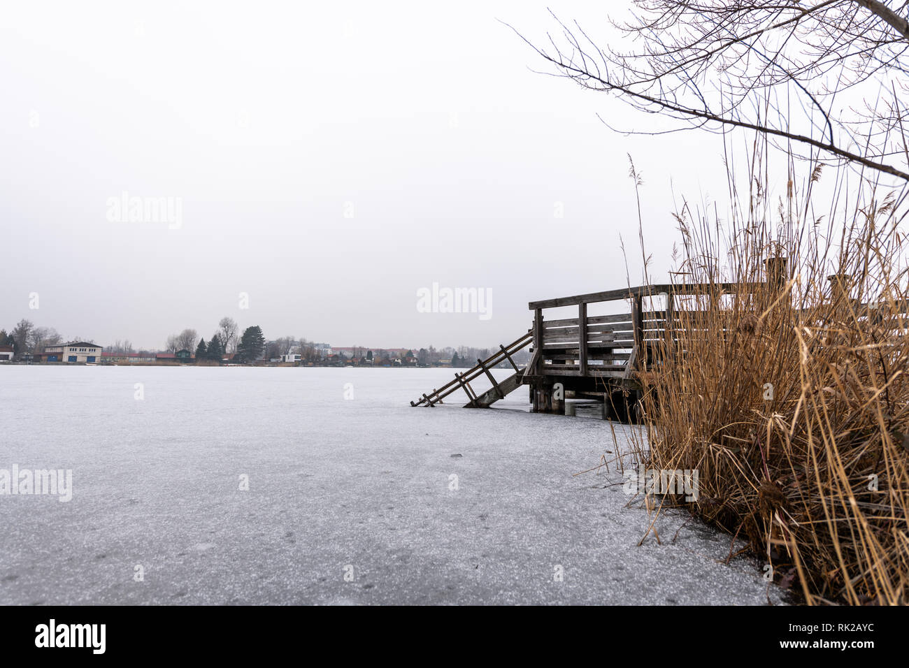 Wooden stairs leading into a frozen lake (Alte Donau, Vienna Austria ...