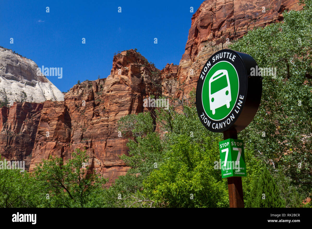 Looking past Zion Shuttle bus stop sign towards Touchstone Wall and Big ...
