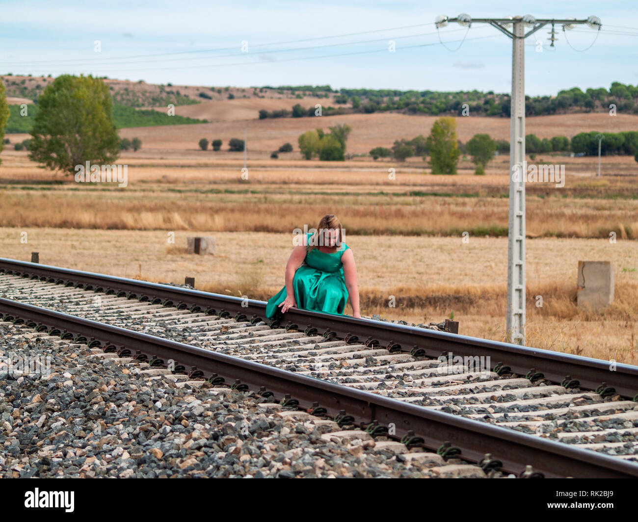 Woman Sitting On Railroad Tracks Stock Photos & Woman Sitting On ...
