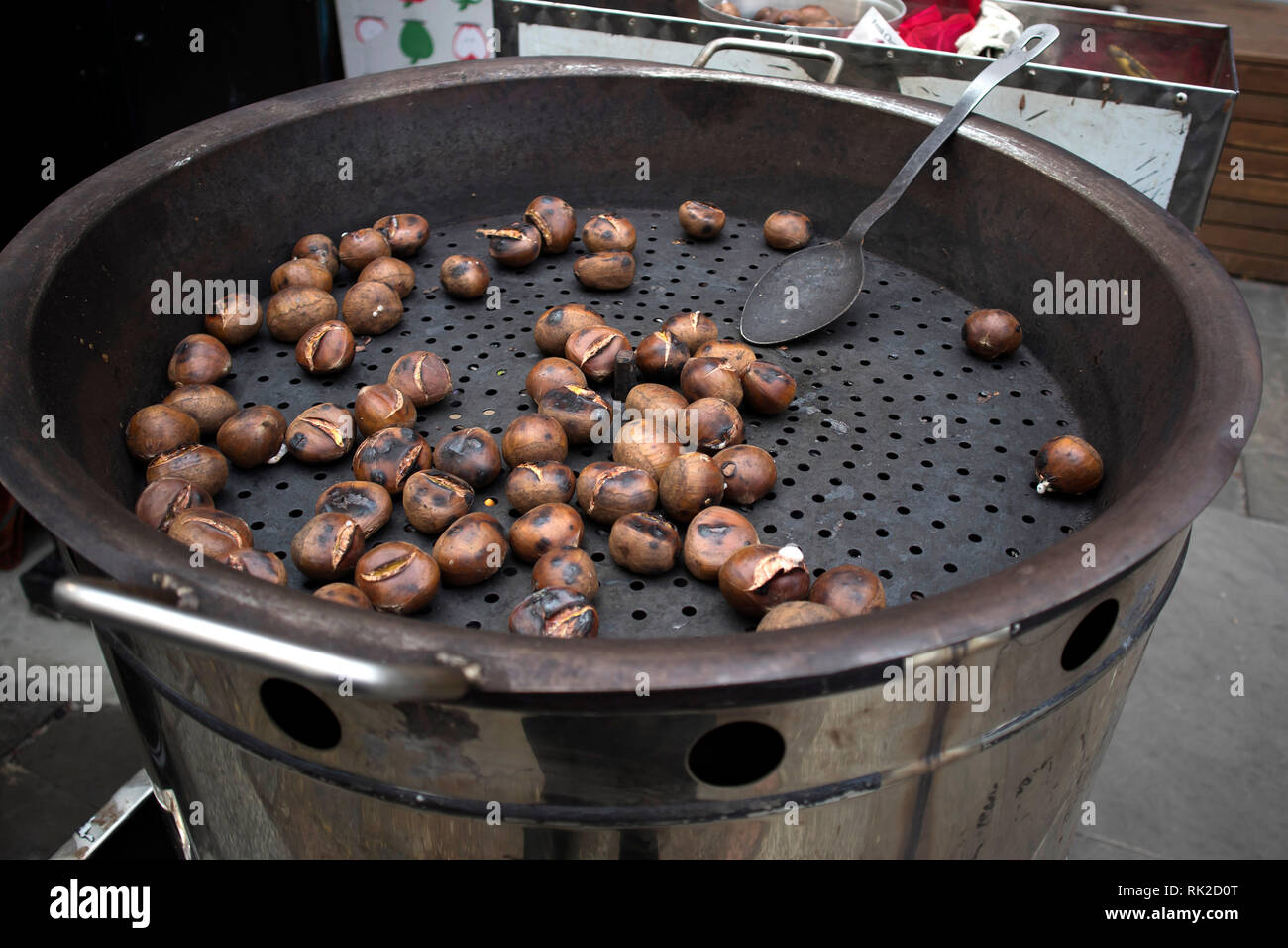 the chestnuts roasted in a large pan for sale on the street Stock Photo ...