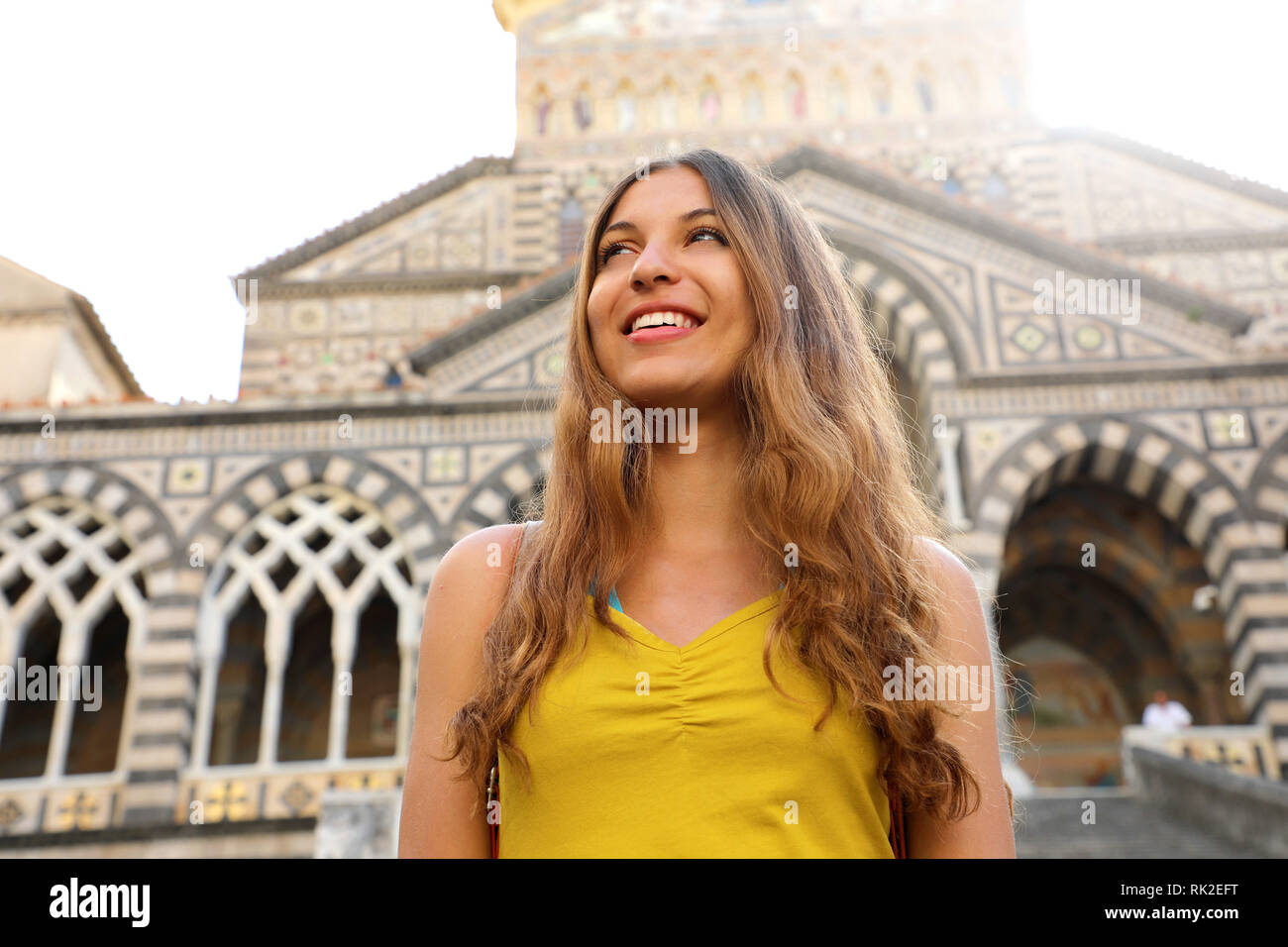 Portrait of young beautiful smiling woman with Amalfi Cathedral on the ...