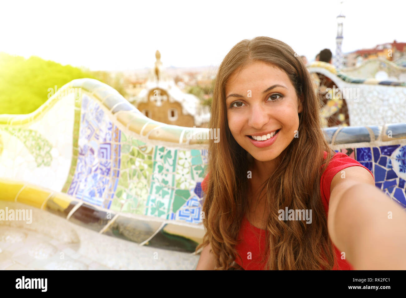 Smiling young woman tourist taking selfie self portrait sitting on the ...