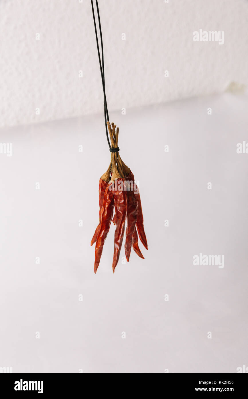 Bunch of dried chilli on white background Stock Photo - Alamy