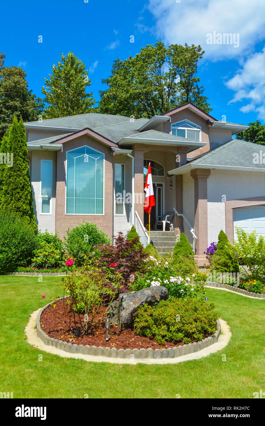 Residential house with Canadian flag at the entrance and decorated ...