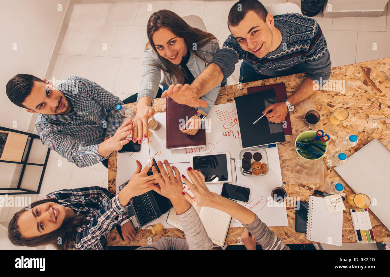 Professional young managers are sitting on the office table and making ...