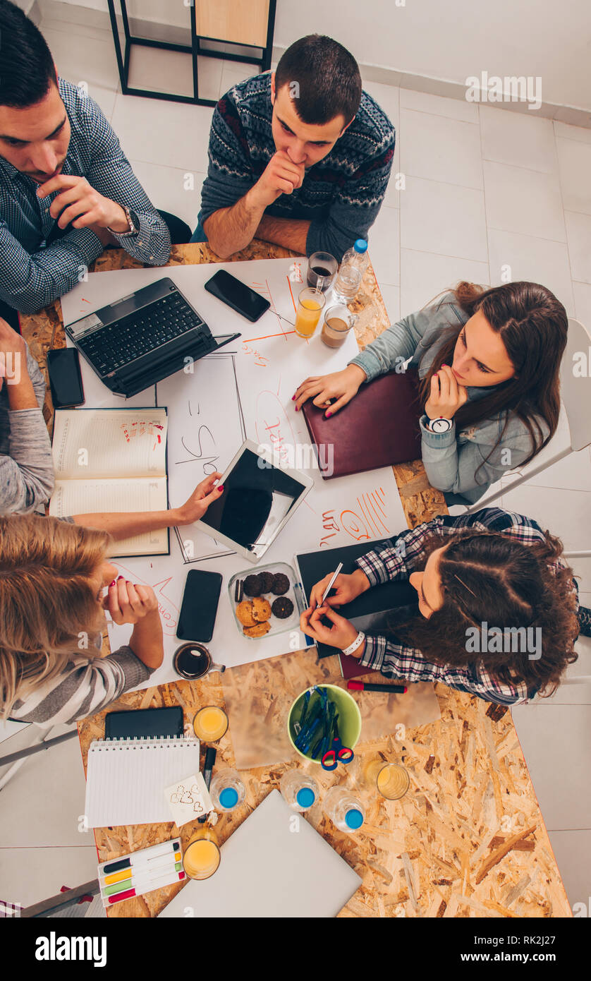 Group of young people disscusing on the table on their workplace Stock ...