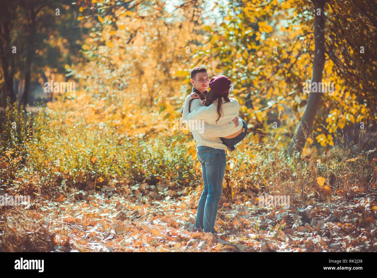 Amorous couple is in the wood, having a great time while the guy is ...