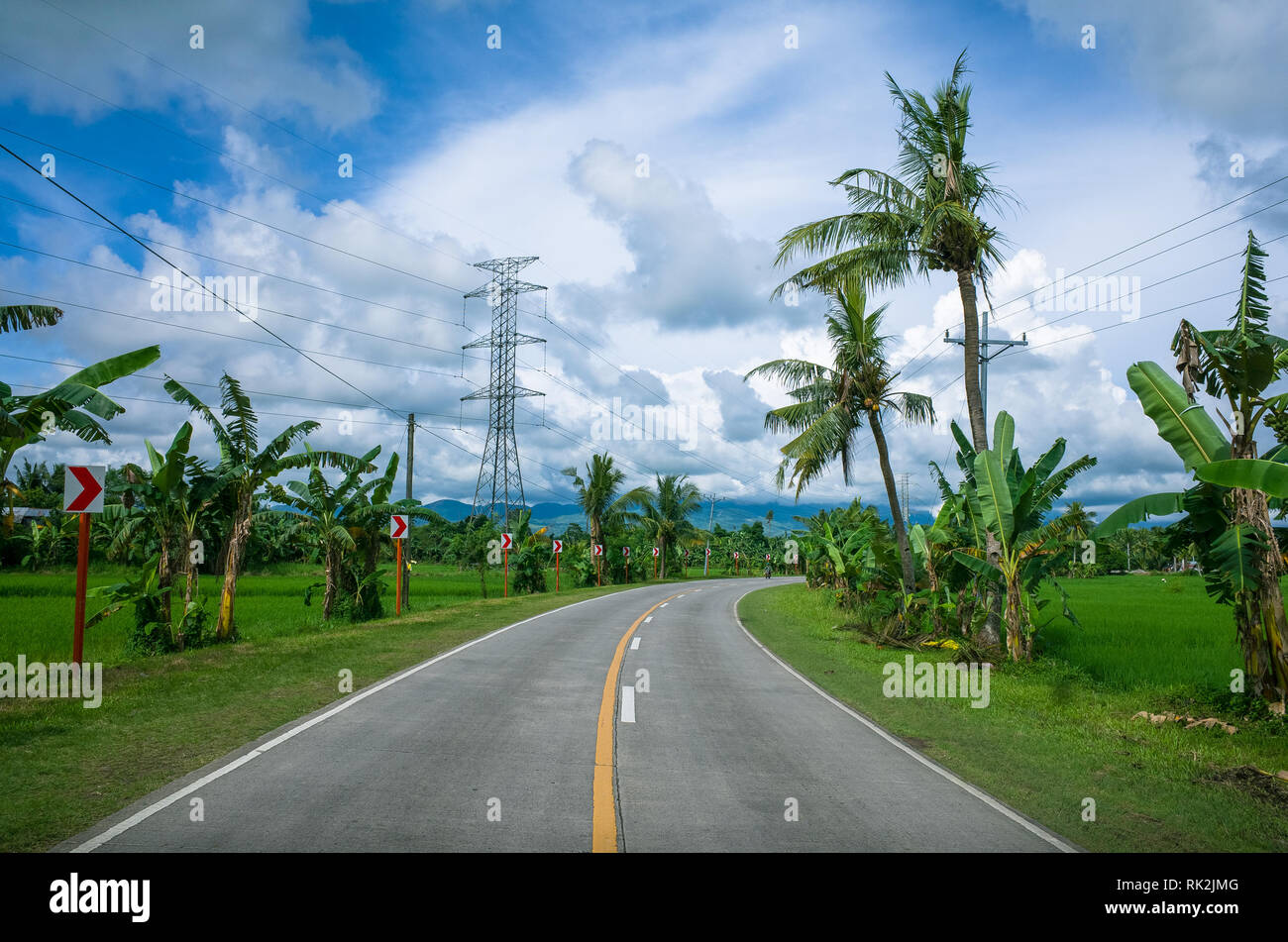Street Curve and Road signs in lush tropical farm countryside - Palo ...