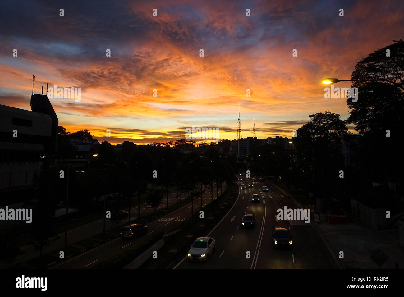 Traffic Headlights and Pink Sunset in Clouds Over Bukit Timah Rd ...