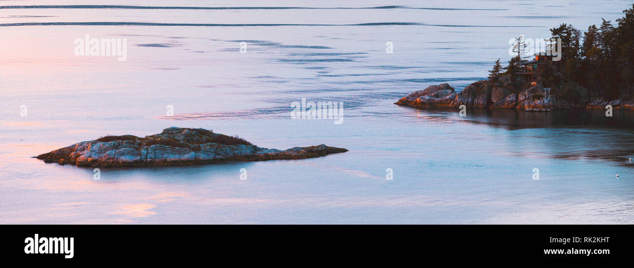 Rocky beach sunsets along the Pacific North West's Bowen Island in Howe ...