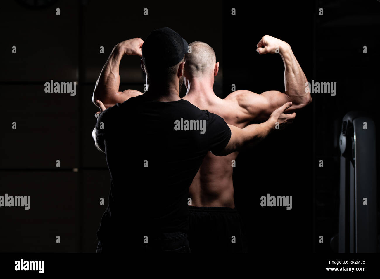 Portrait Of A Man Posing Bodybuilding Poses In Fitness Center and ...