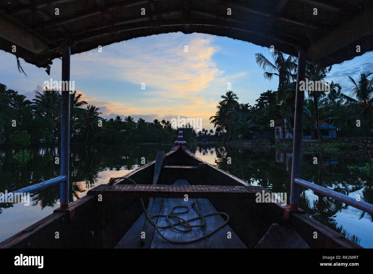 View of river from inside a native boat in rural India at twilight ...