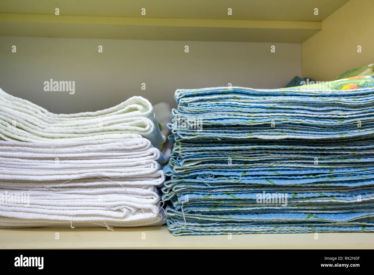 Interior of white plastic cabinet or clothing wardrobe with stacked ...