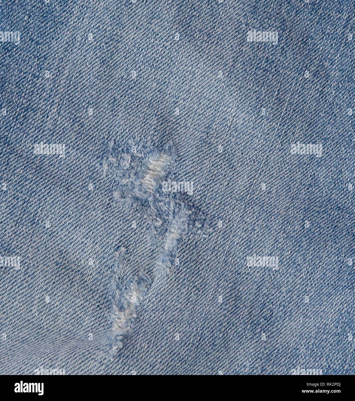 Hole and Threads on Denim Jeans. Ripped Destroyed Torn Blue jeans ...