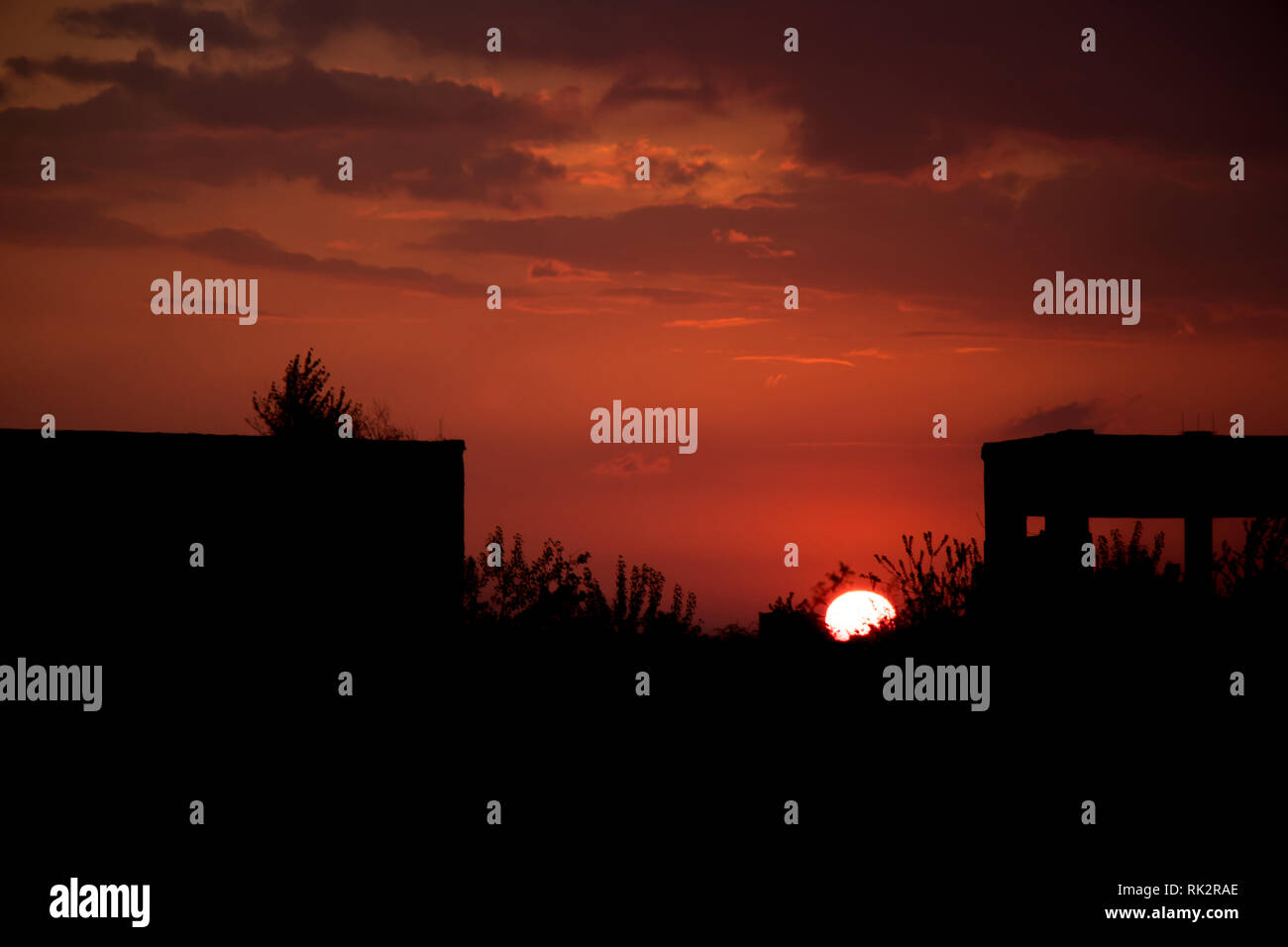 Sun set building in dark shadow Stock Photo - Alamy