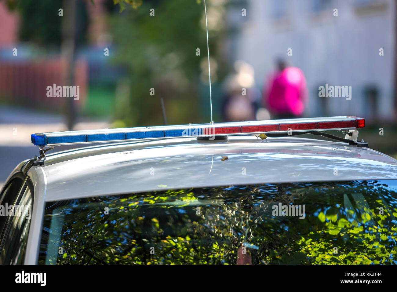 White police car cruiser with emergency lights parked on sunny summer ...