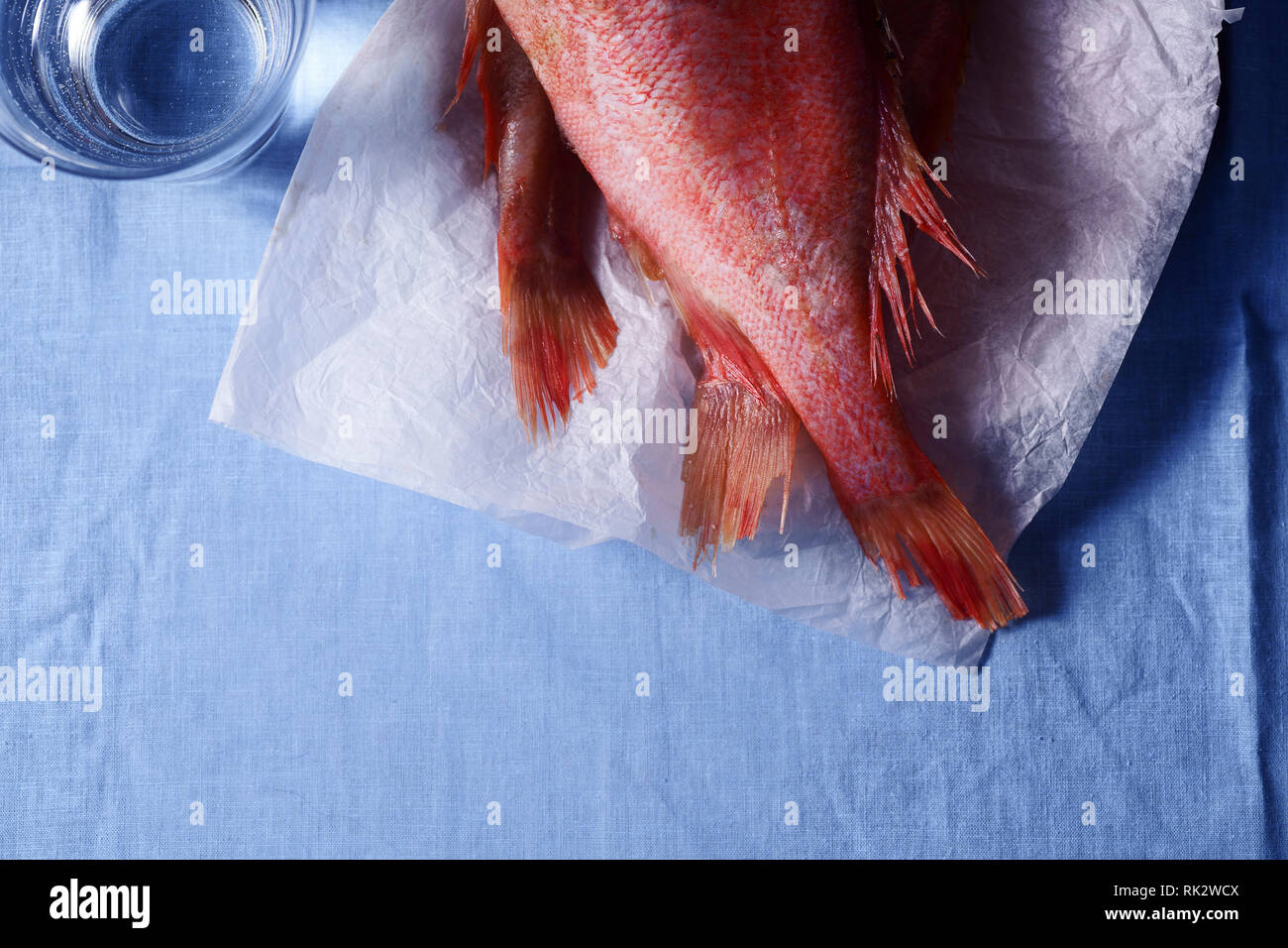 Raw uncooked fish perch on blue linen Stock Photo - Alamy