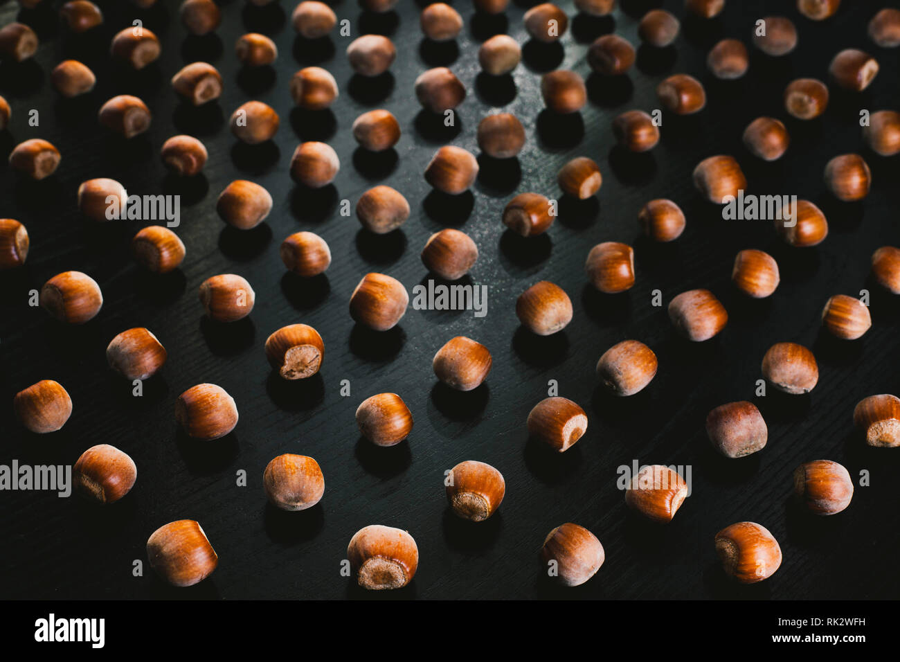 Forest hazelnuts on a black background Stock Photo - Alamy