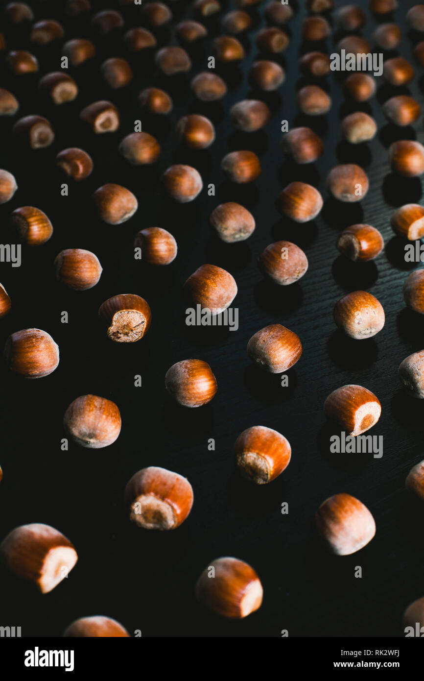 Forest hazelnuts on a black background Stock Photo - Alamy