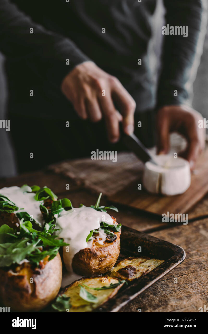 Mans hand cutting cheese hi-res stock photography and images - Alamy